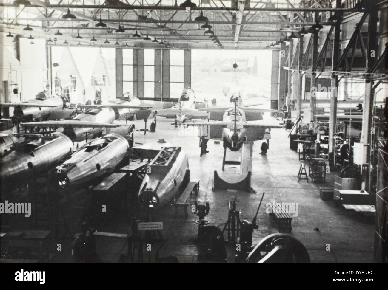 This photo captures the interior of an aircraft factory, showcasing the ...