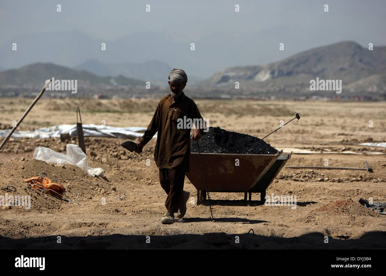 Kabul, Afghanistan. 19th Apr, 2014. An Afghan labor works at a brick ...