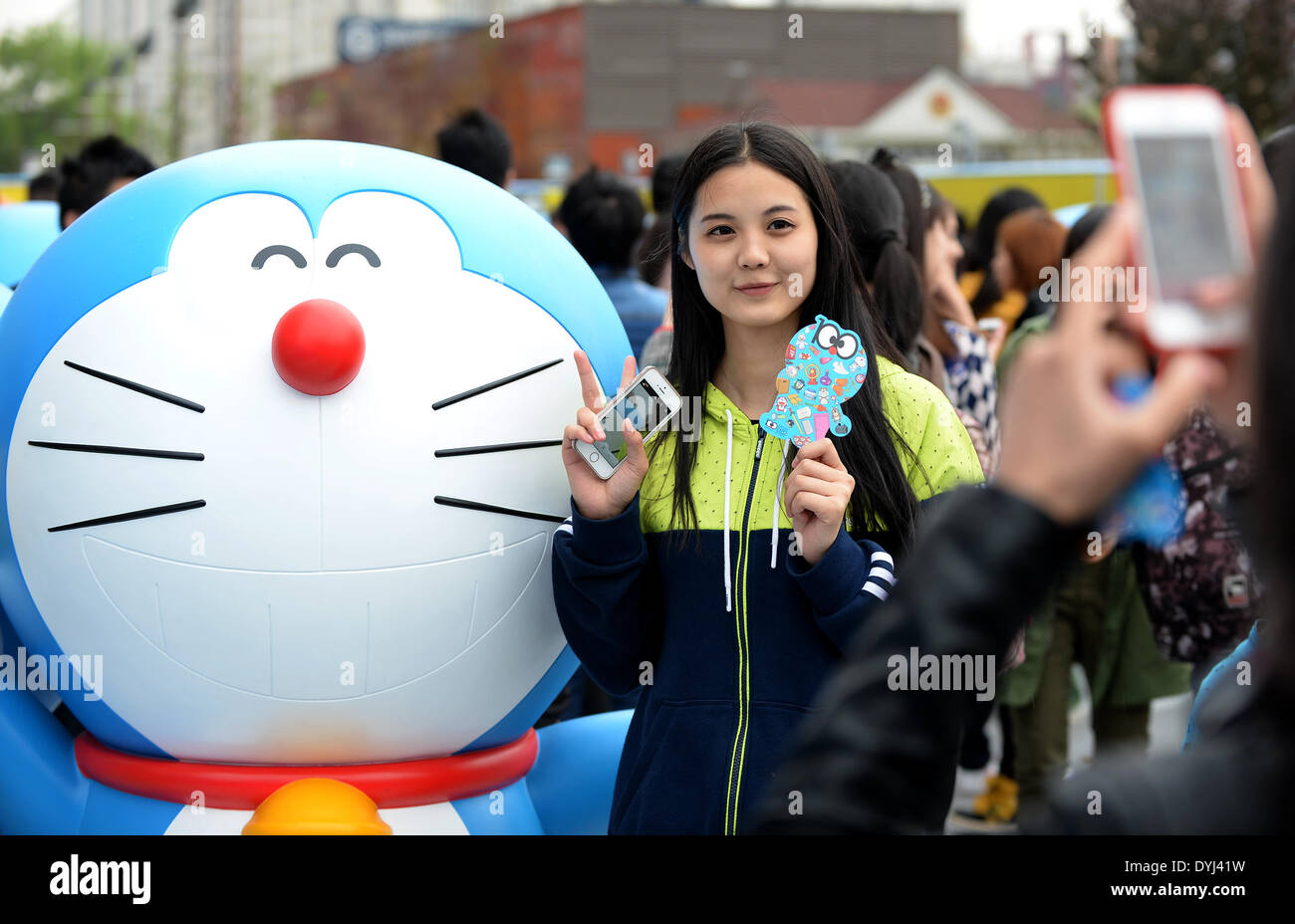 Beijing, China. 19th Apr, 2014. A visitor poses for a photo with a ...