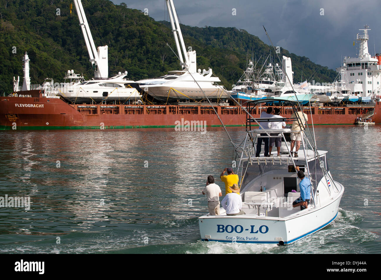 Watching a Sevenstar cargo ship carrying yachts strapped down as deck ...
