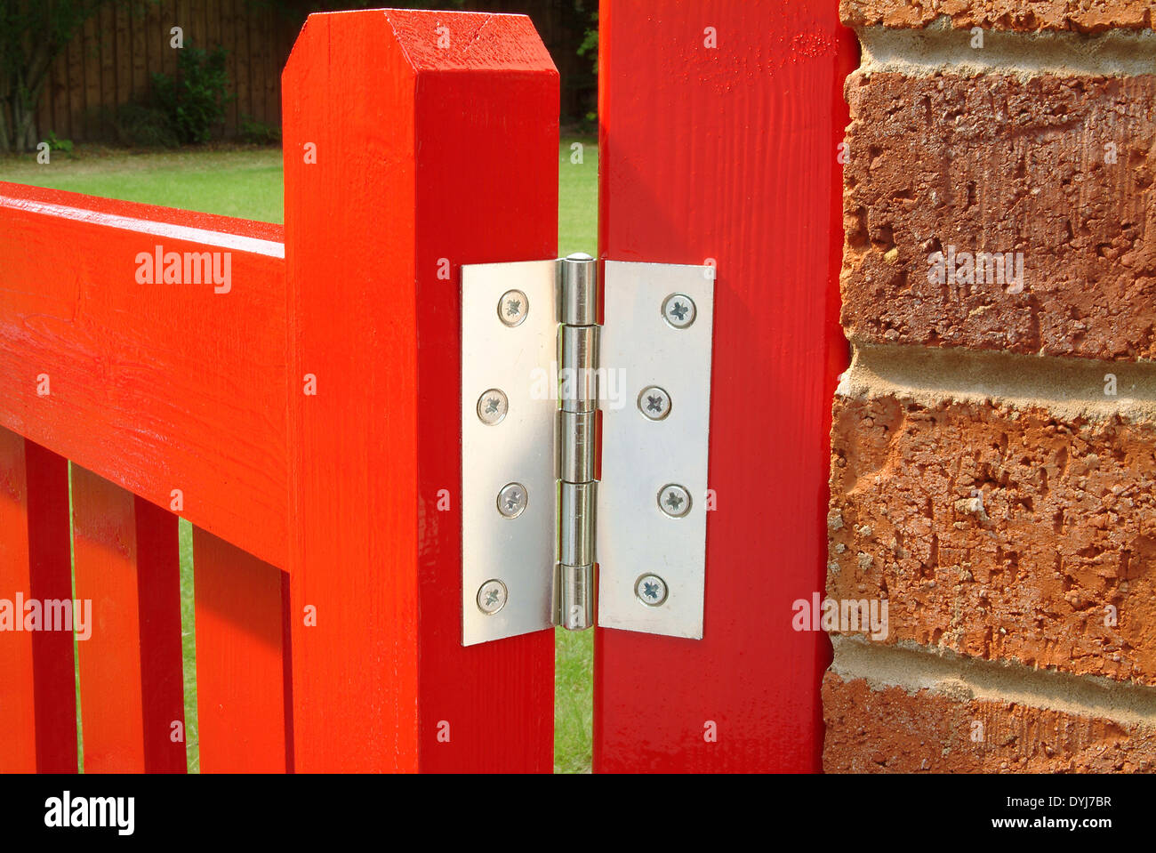 Nickel-plated hinge on garden gate Stock Photo - Alamy