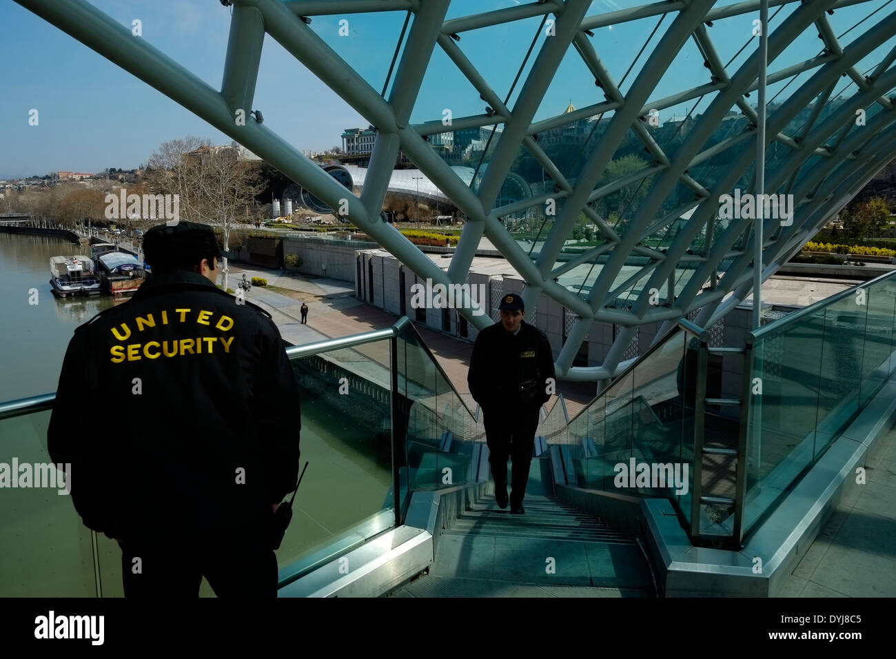 Security guards at the bow-shaped pedestrian Bridge of Peace over the ...