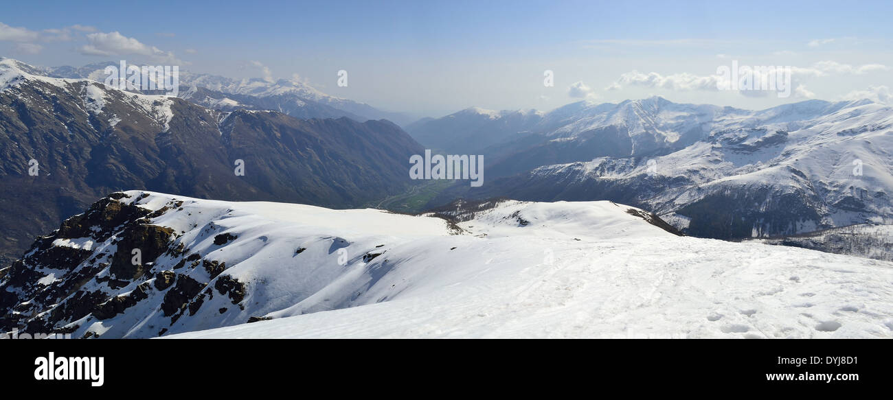 Aerial view of the alpine arc with misty valleys and peaks due to the ...
