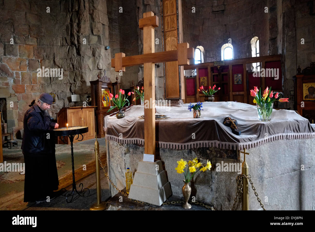 A Georgian Orthodox priest lights candles at the 6th century Georgian ...