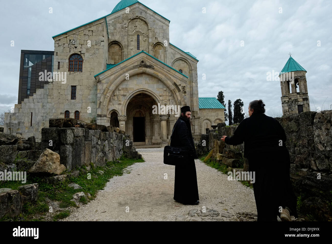 Georgian Orthodox priest chatting in front of the 11th century ...