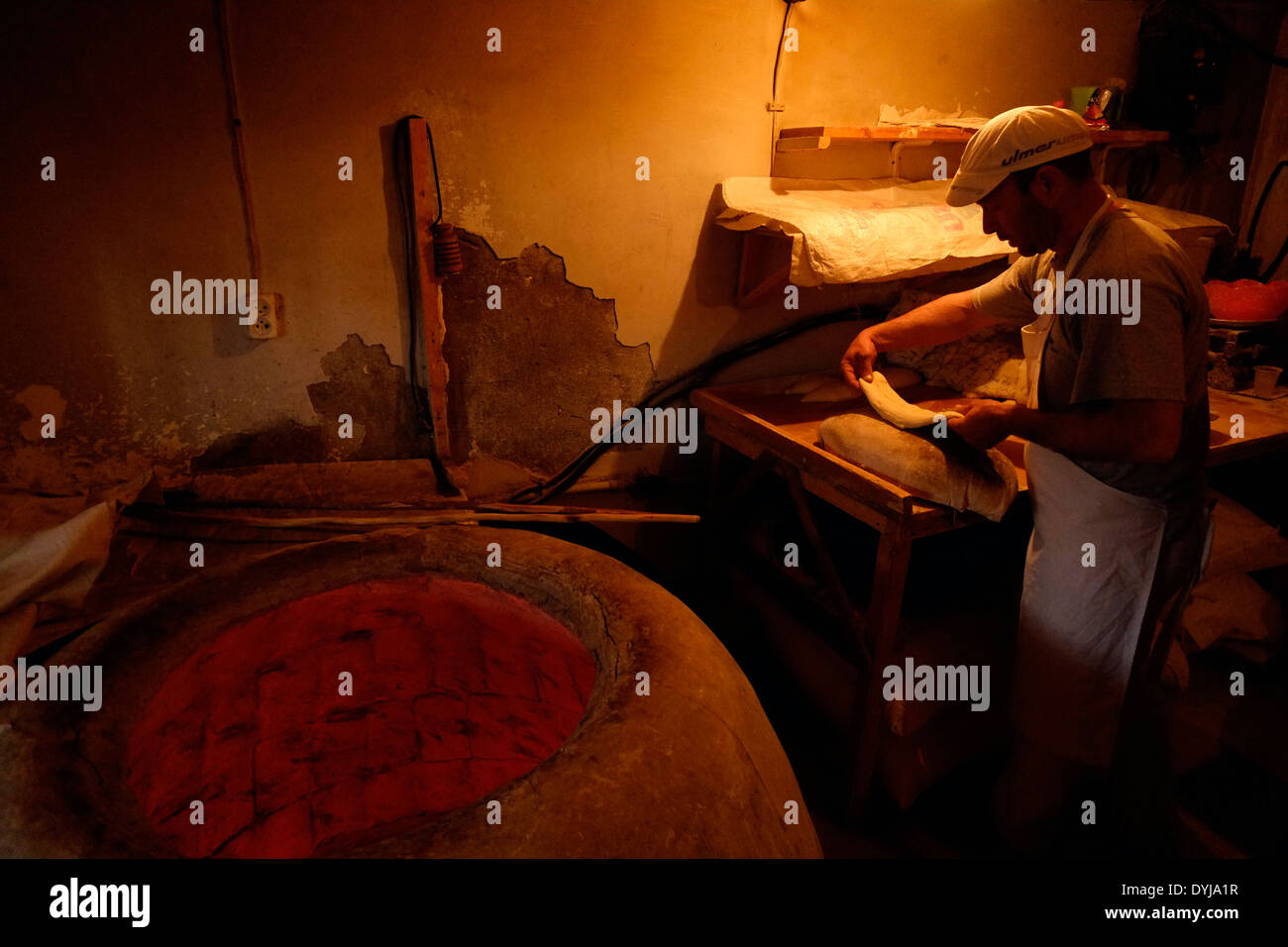 A Georgian baker kneading dough of traditional Georgian bread called ...