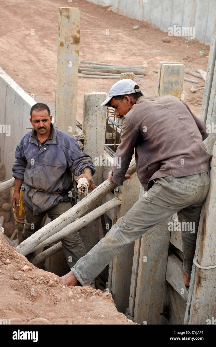 Construction workmen installing traditional timber formwork for ...