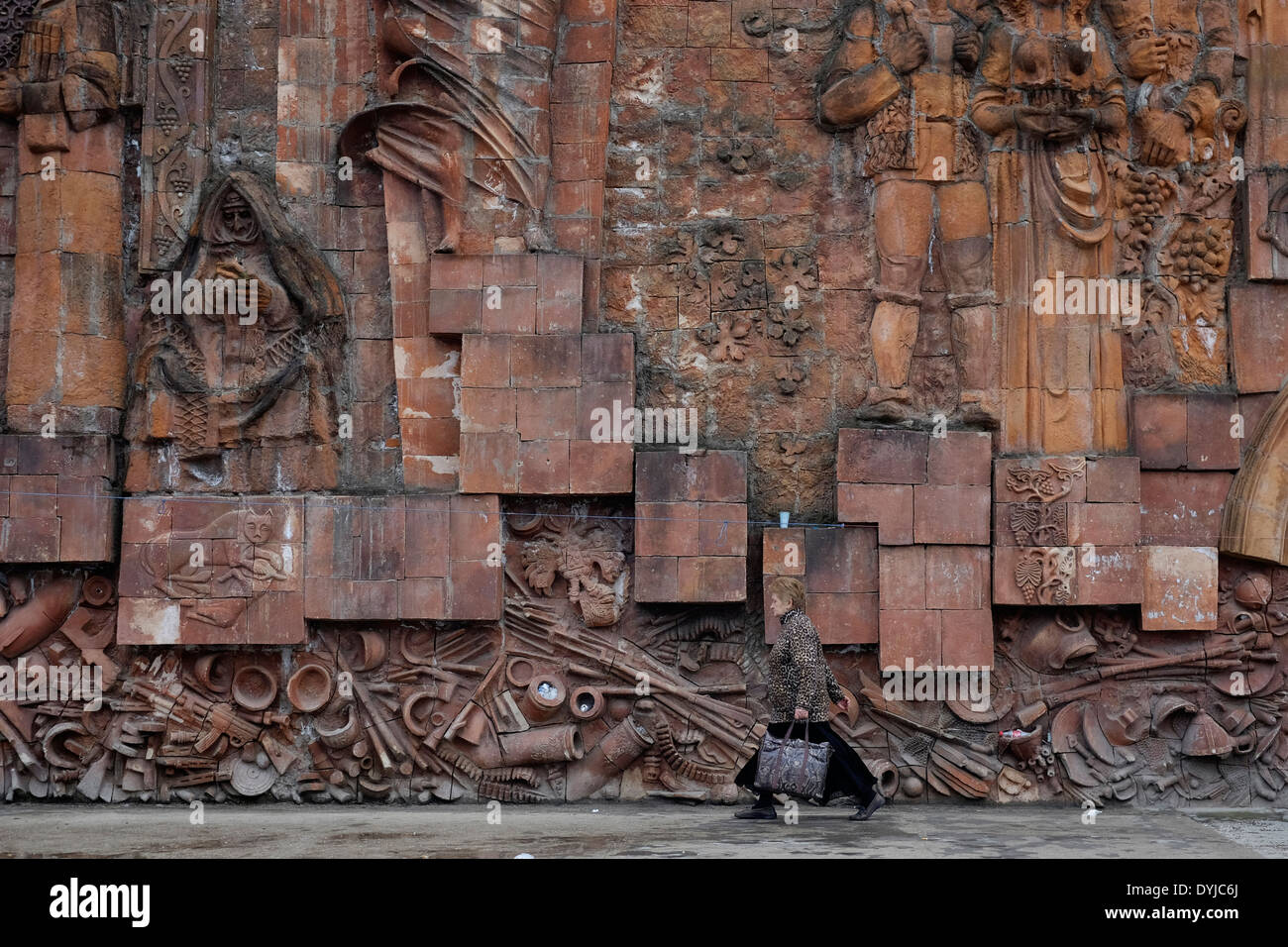 A pedestrian walk past a Soviet era relief wall at the entrance to the ...