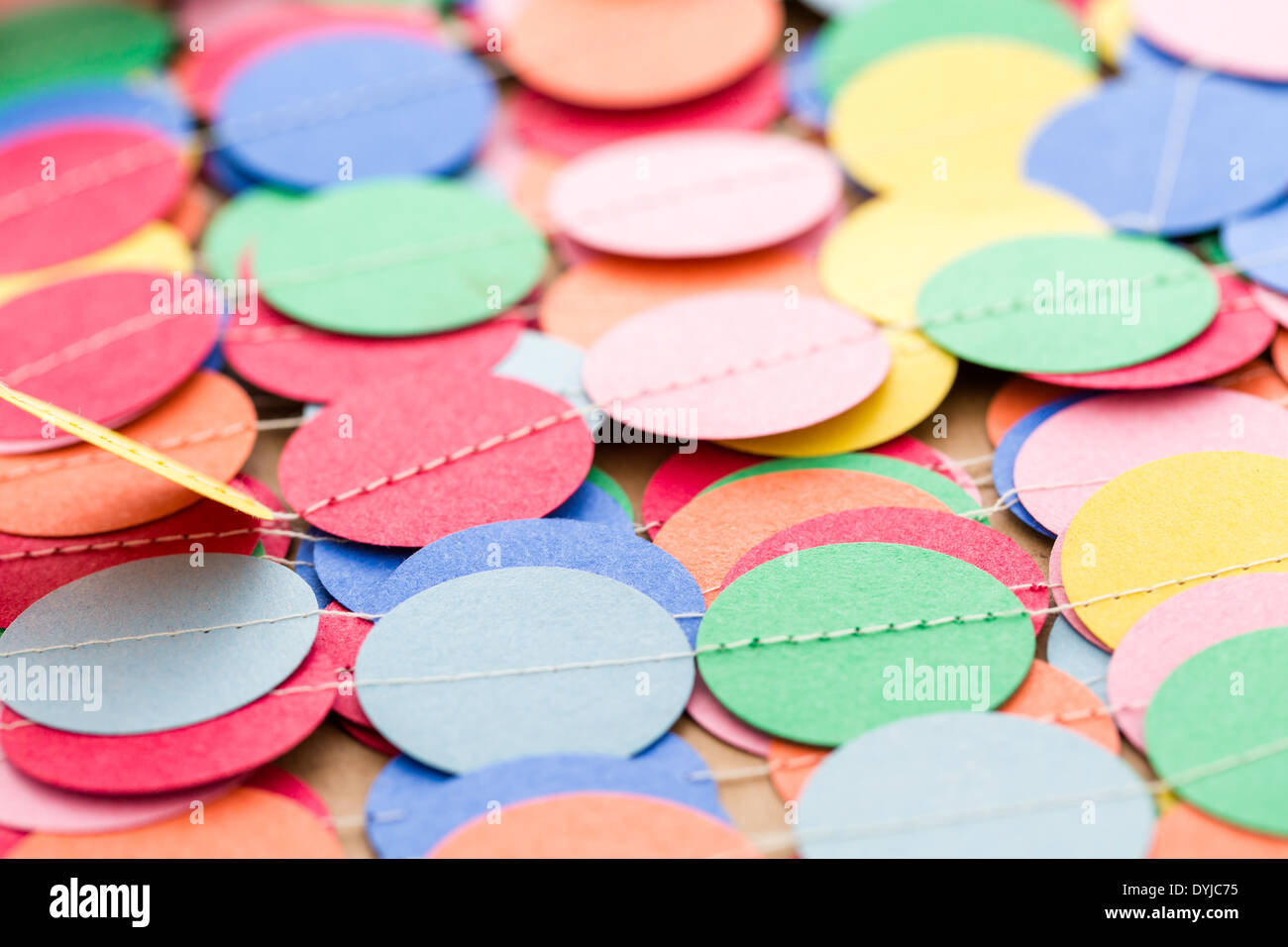 Making a colorful paper garland with reound puncher Stock Photo - Alamy