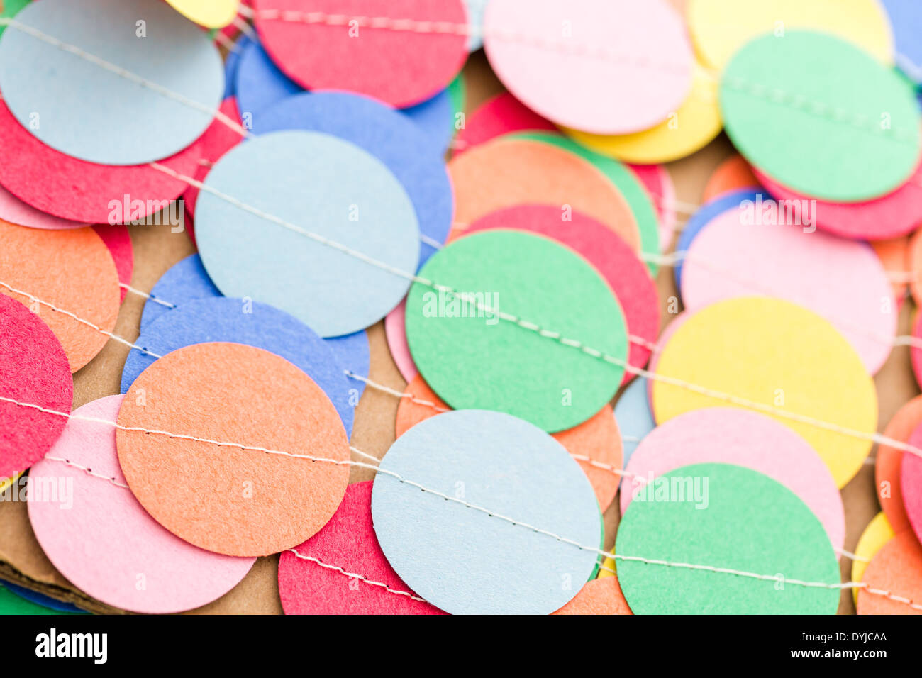 Making a colorful paper garland with reound puncher Stock Photo - Alamy