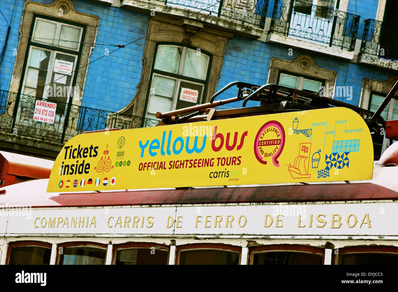 Vintage tram with city tours advert on roof passing traditional old ...