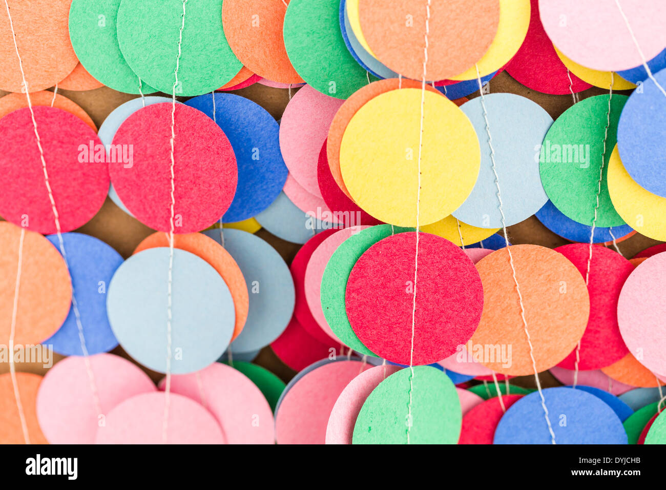 Making a colorful paper garland with reound puncher Stock Photo - Alamy