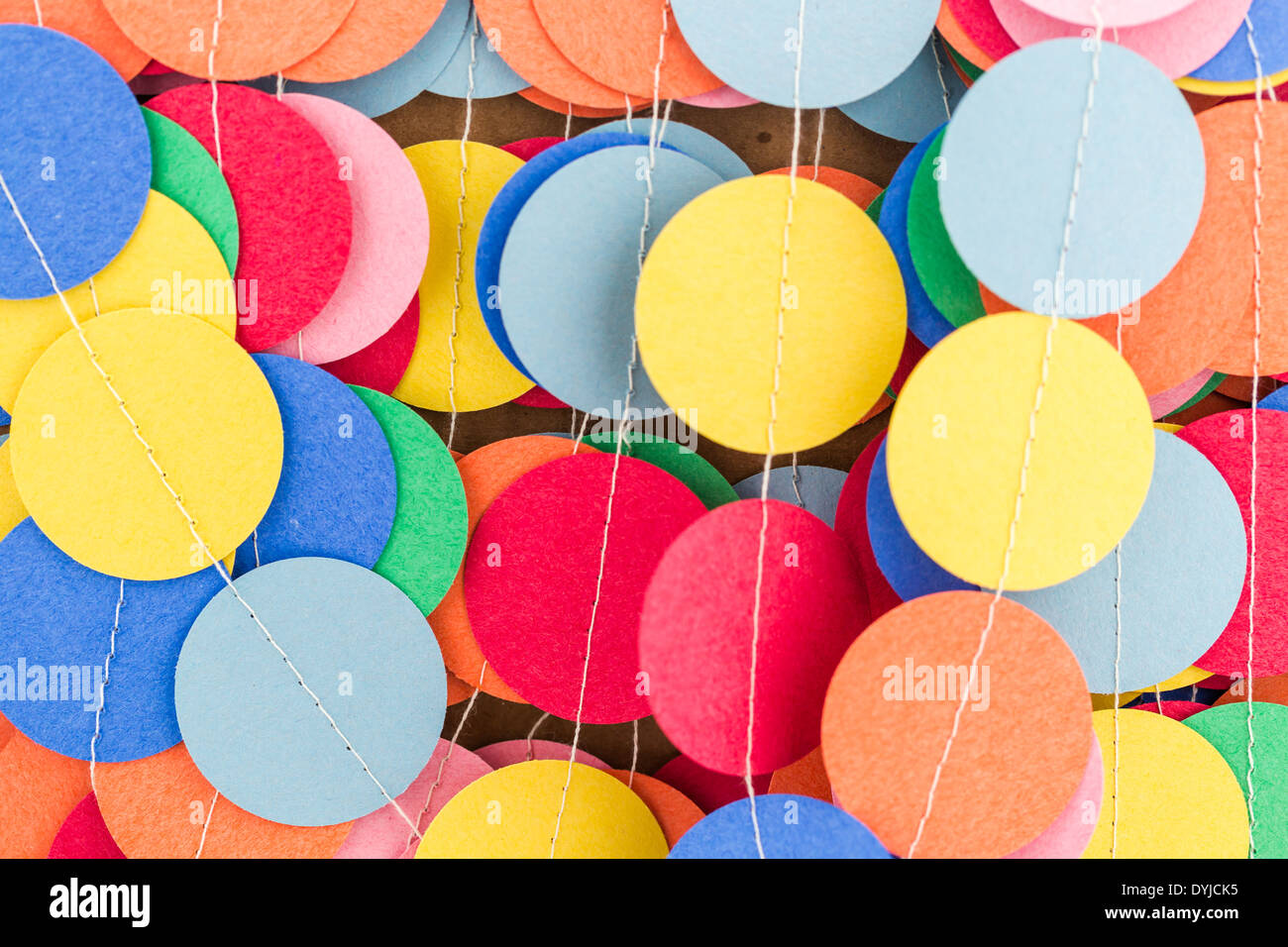 Making a colorful paper garland with reound puncher Stock Photo - Alamy
