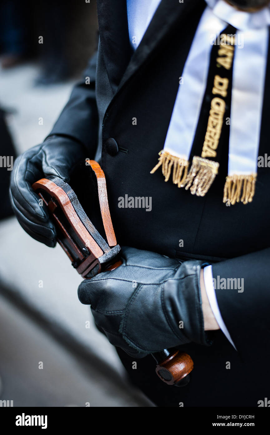 Palermo, Italy. 18th Apr, 2014. A man holds a wooden clapper, used to ...