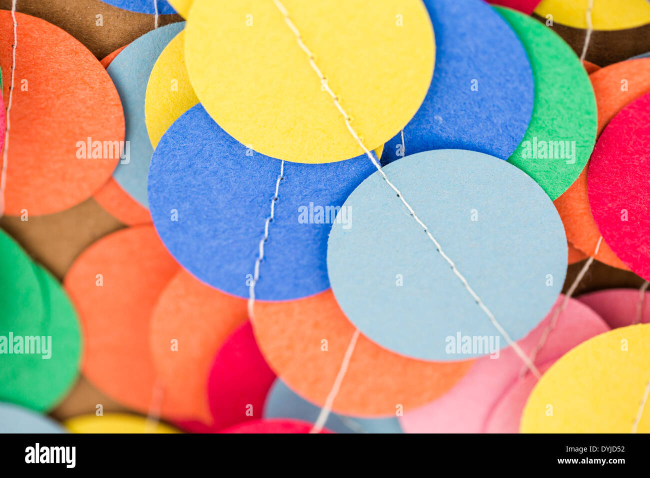 Making a colorful paper garland with reound puncher Stock Photo - Alamy