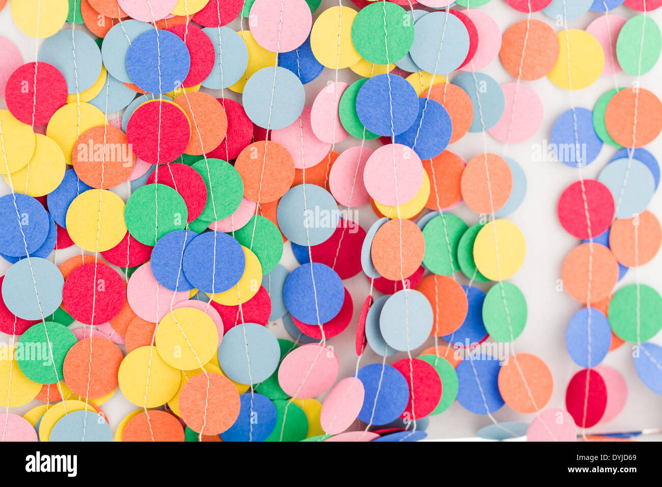 Making a colorful paper garland with reound puncher Stock Photo - Alamy