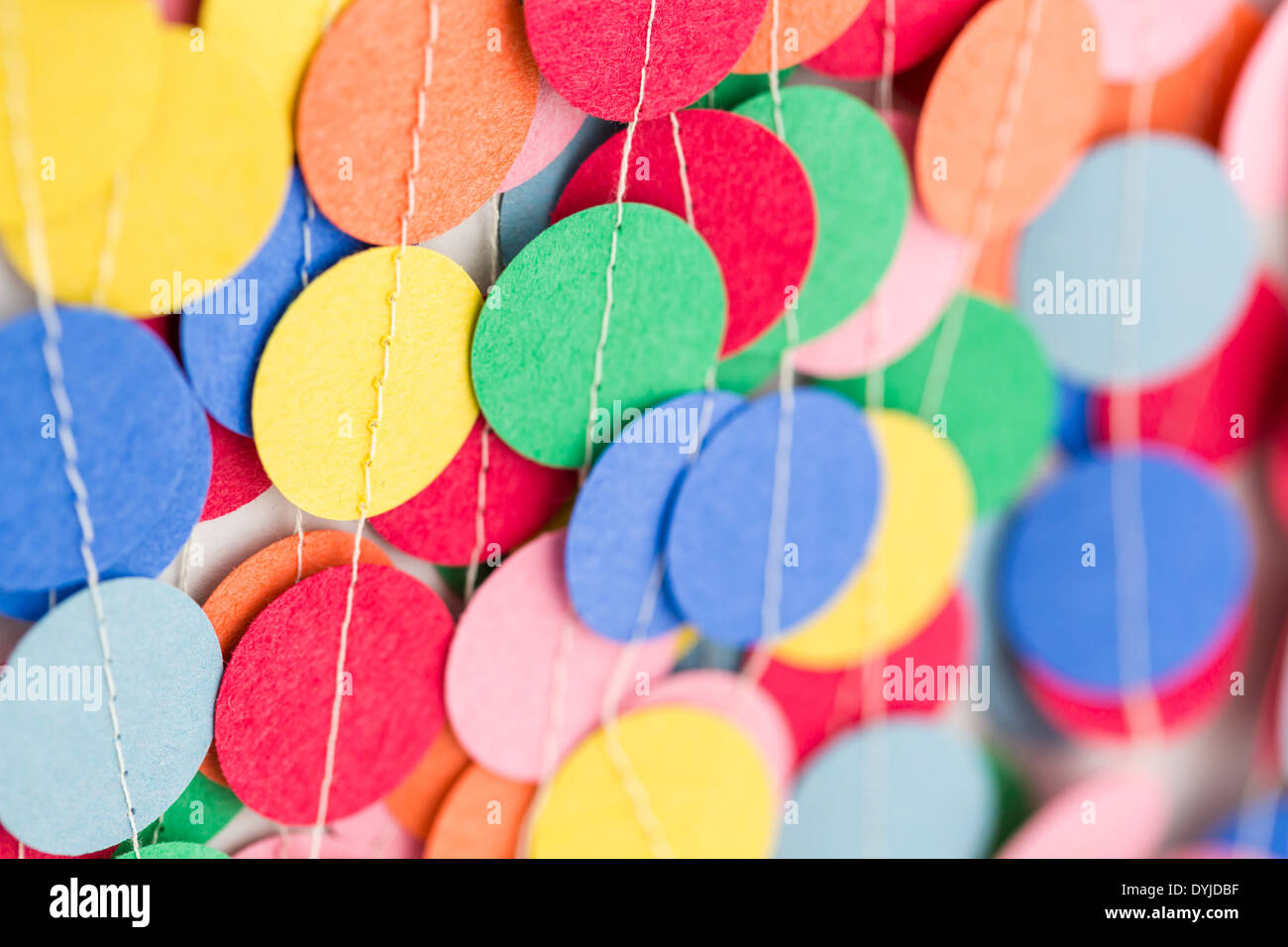 Making a colorful paper garland with reound puncher Stock Photo - Alamy