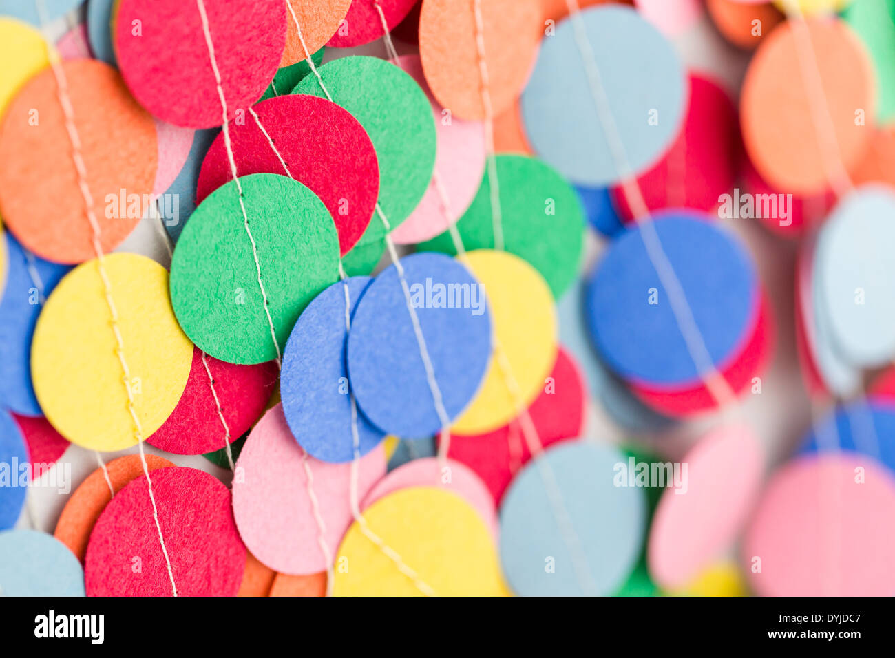 Making a colorful paper garland with reound puncher Stock Photo - Alamy