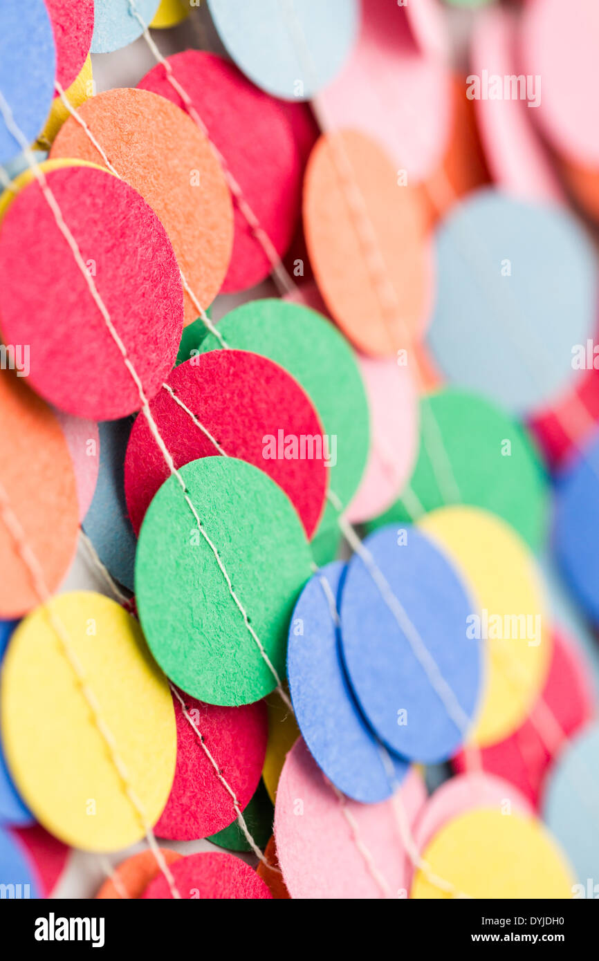 Making a colorful paper garland with reound puncher Stock Photo - Alamy