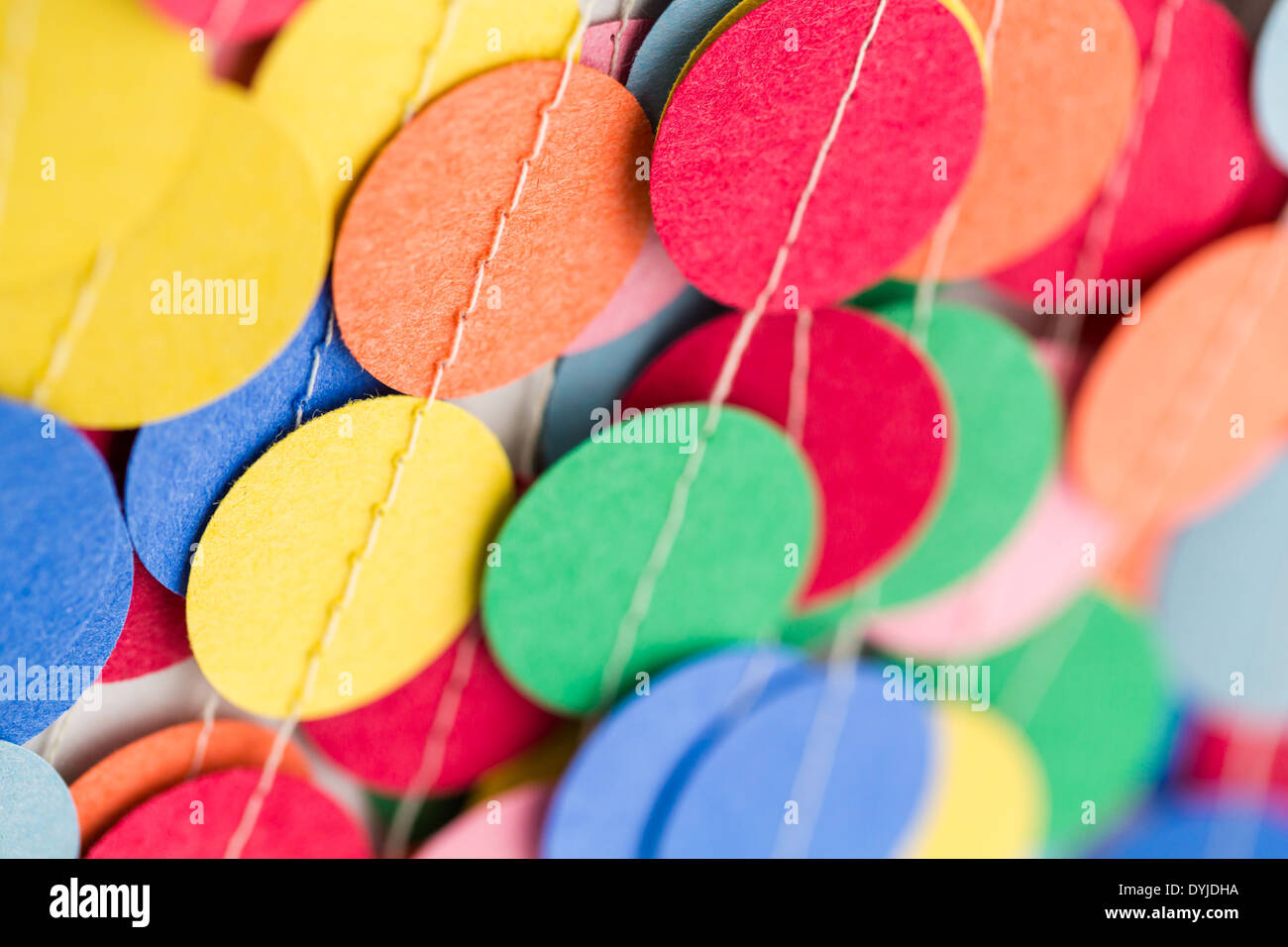 Making a colorful paper garland with reound puncher Stock Photo - Alamy