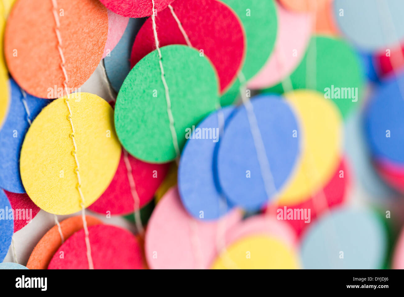 Making a colorful paper garland with reound puncher Stock Photo - Alamy