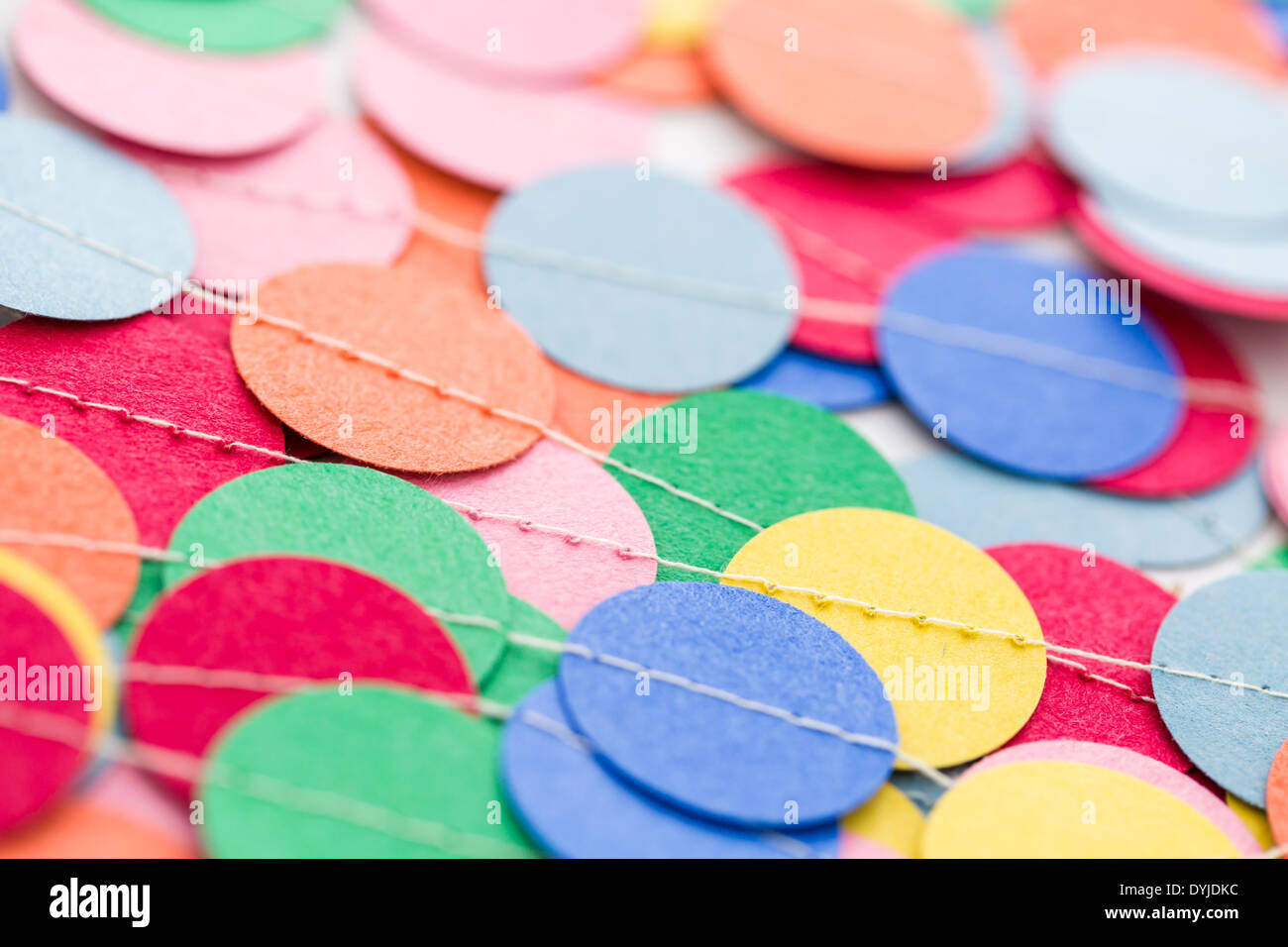 Making a colorful paper garland with reound puncher Stock Photo - Alamy