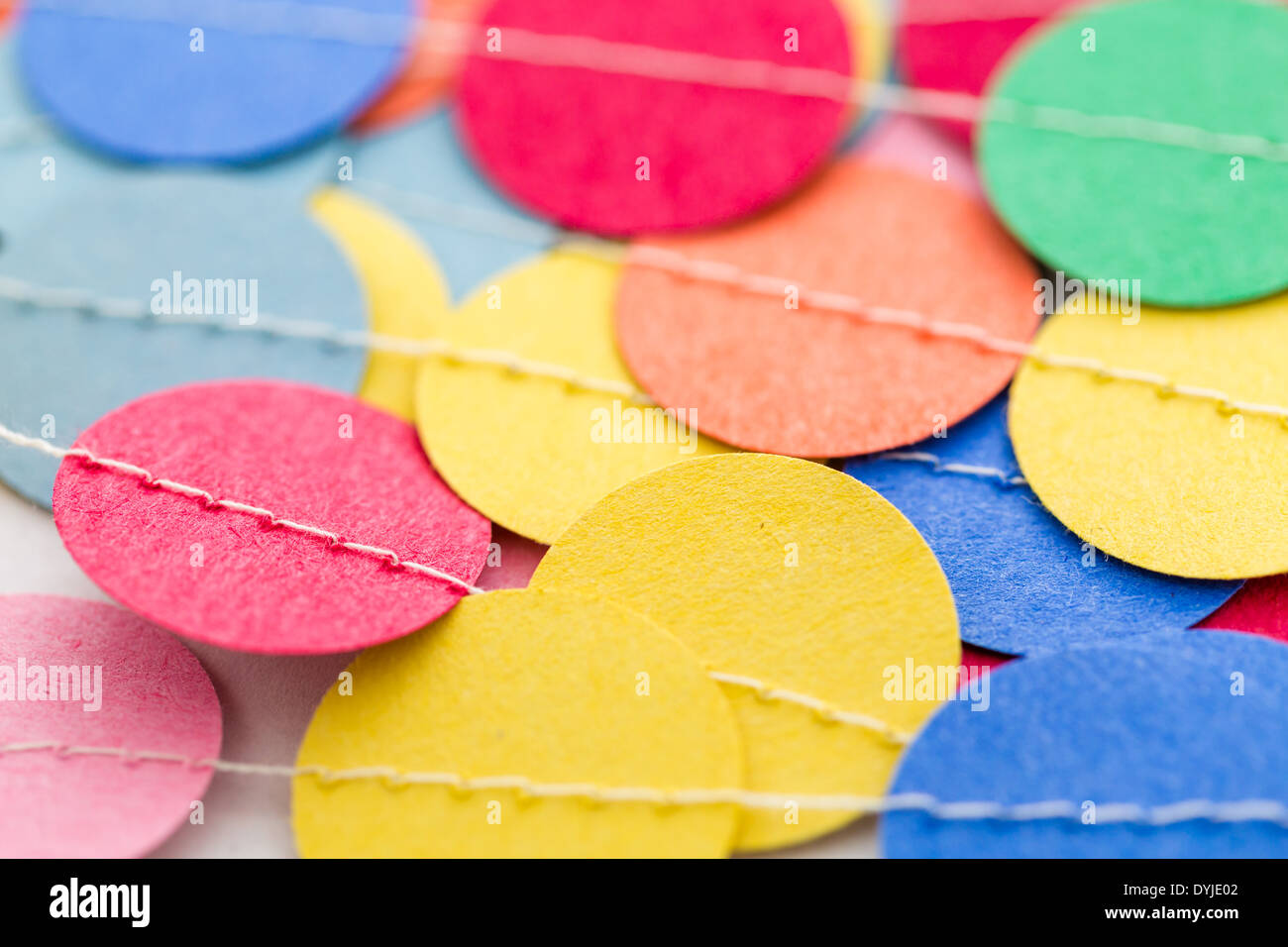 Making a colorful paper garland with reound puncher Stock Photo - Alamy