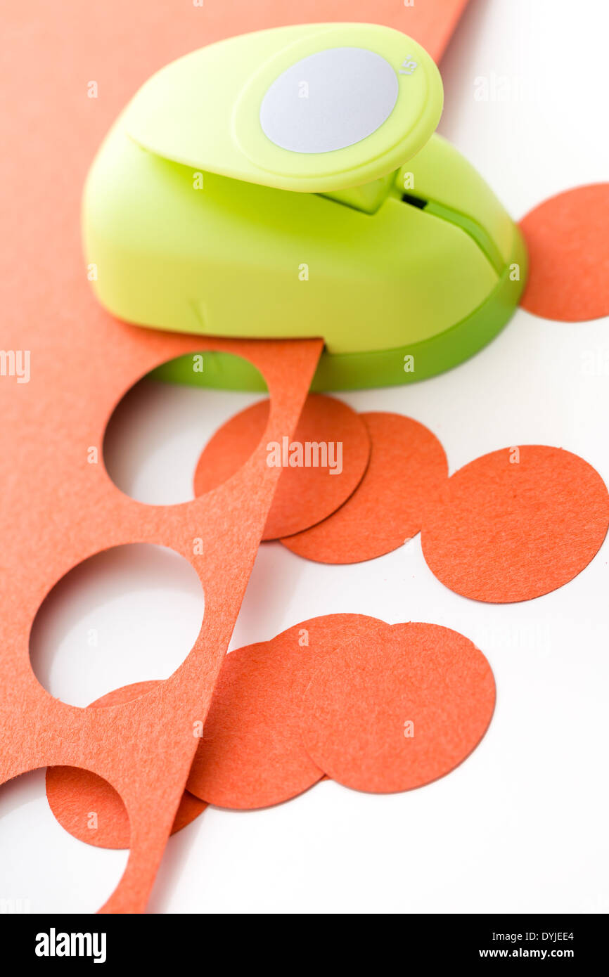 Making a colorful paper garland with reound puncher Stock Photo - Alamy