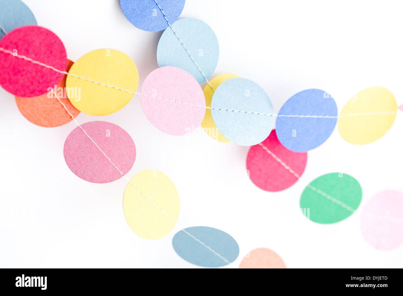 Making a colorful paper garland with reound puncher Stock Photo - Alamy