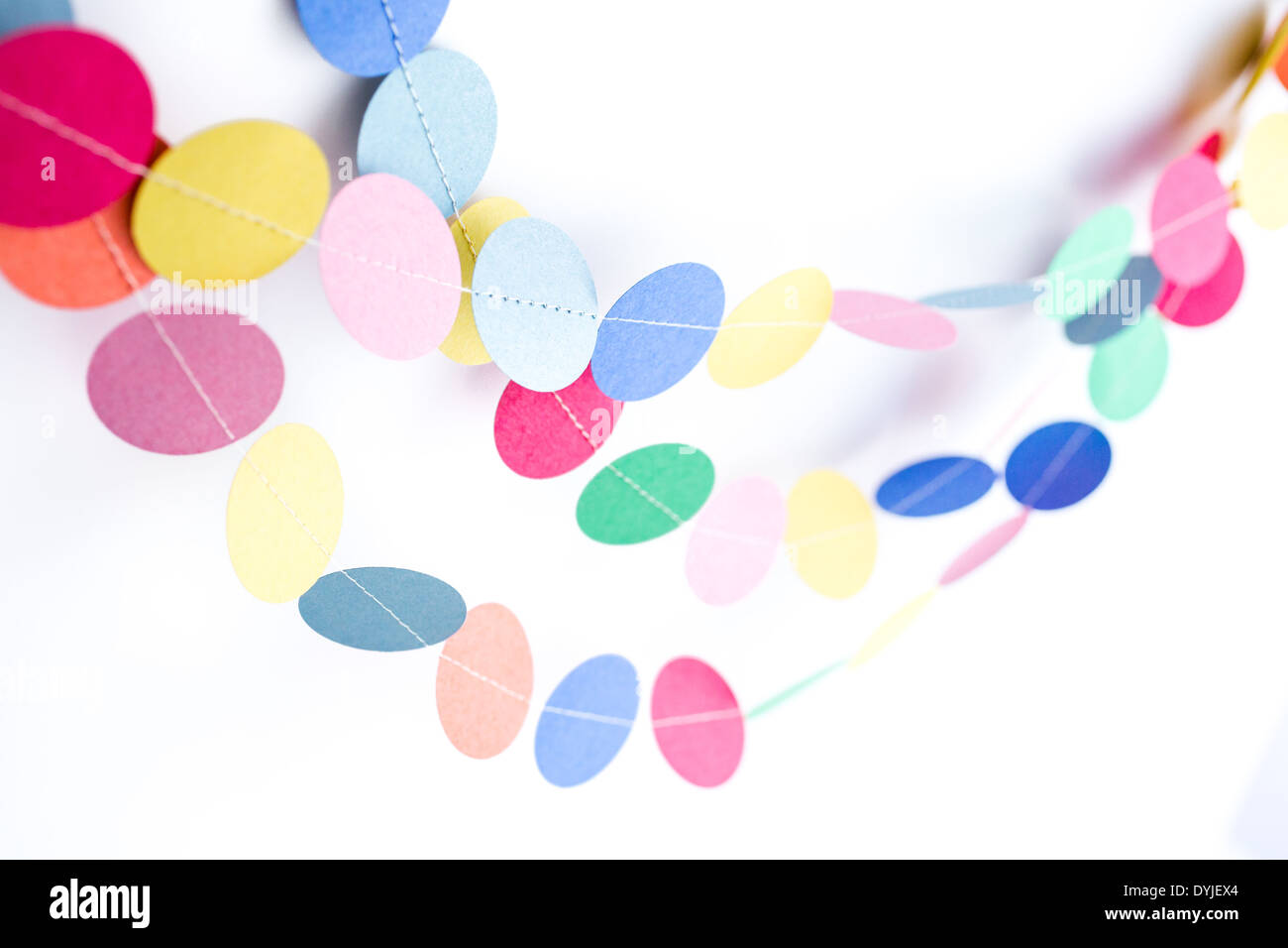 Making a colorful paper garland with reound puncher Stock Photo - Alamy
