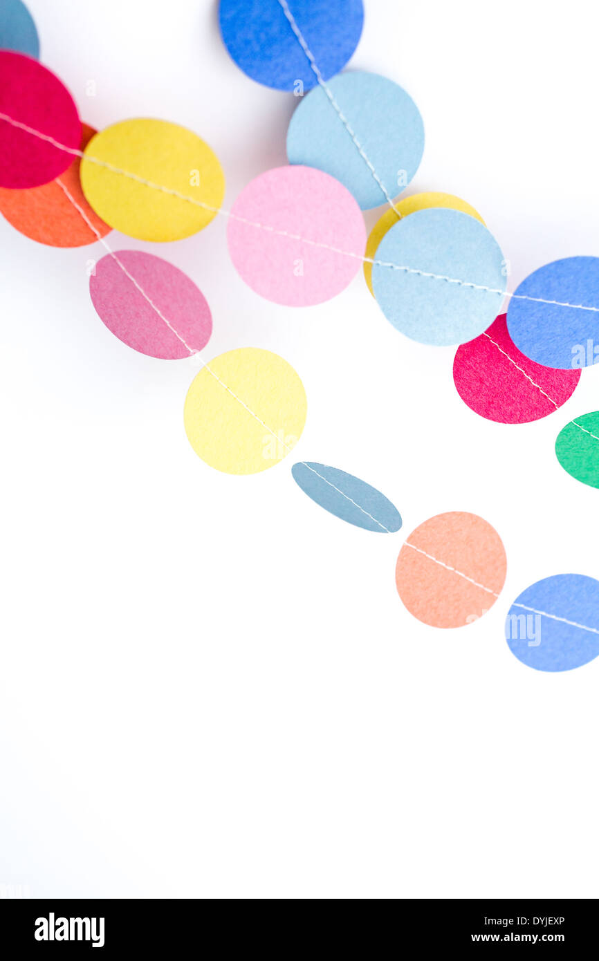Making a colorful paper garland with reound puncher Stock Photo - Alamy