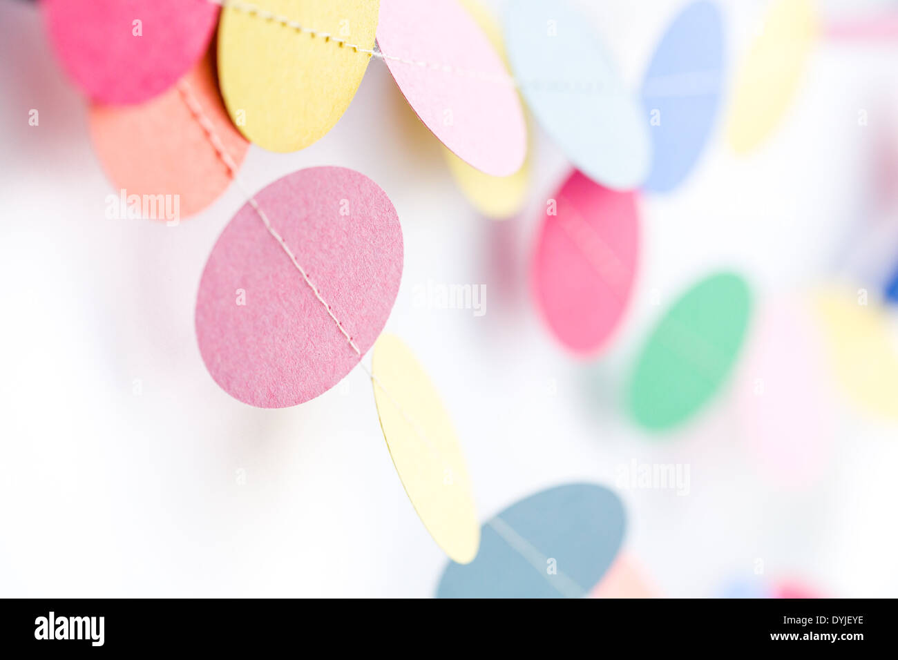 Making a colorful paper garland with reound puncher Stock Photo - Alamy