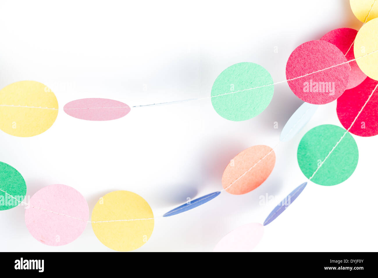 Making a colorful paper garland with reound puncher Stock Photo - Alamy