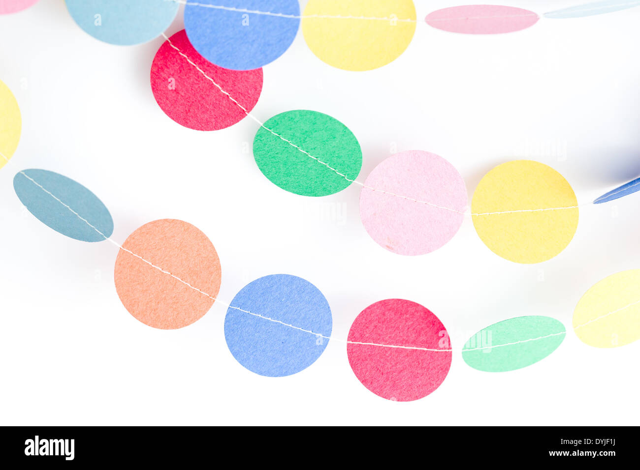 Making a colorful paper garland with reound puncher Stock Photo - Alamy