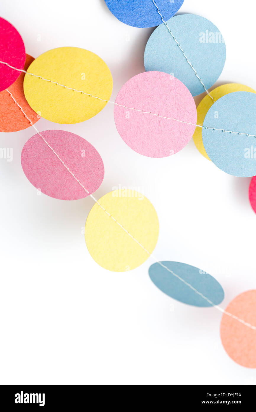 Making a colorful paper garland with reound puncher Stock Photo - Alamy