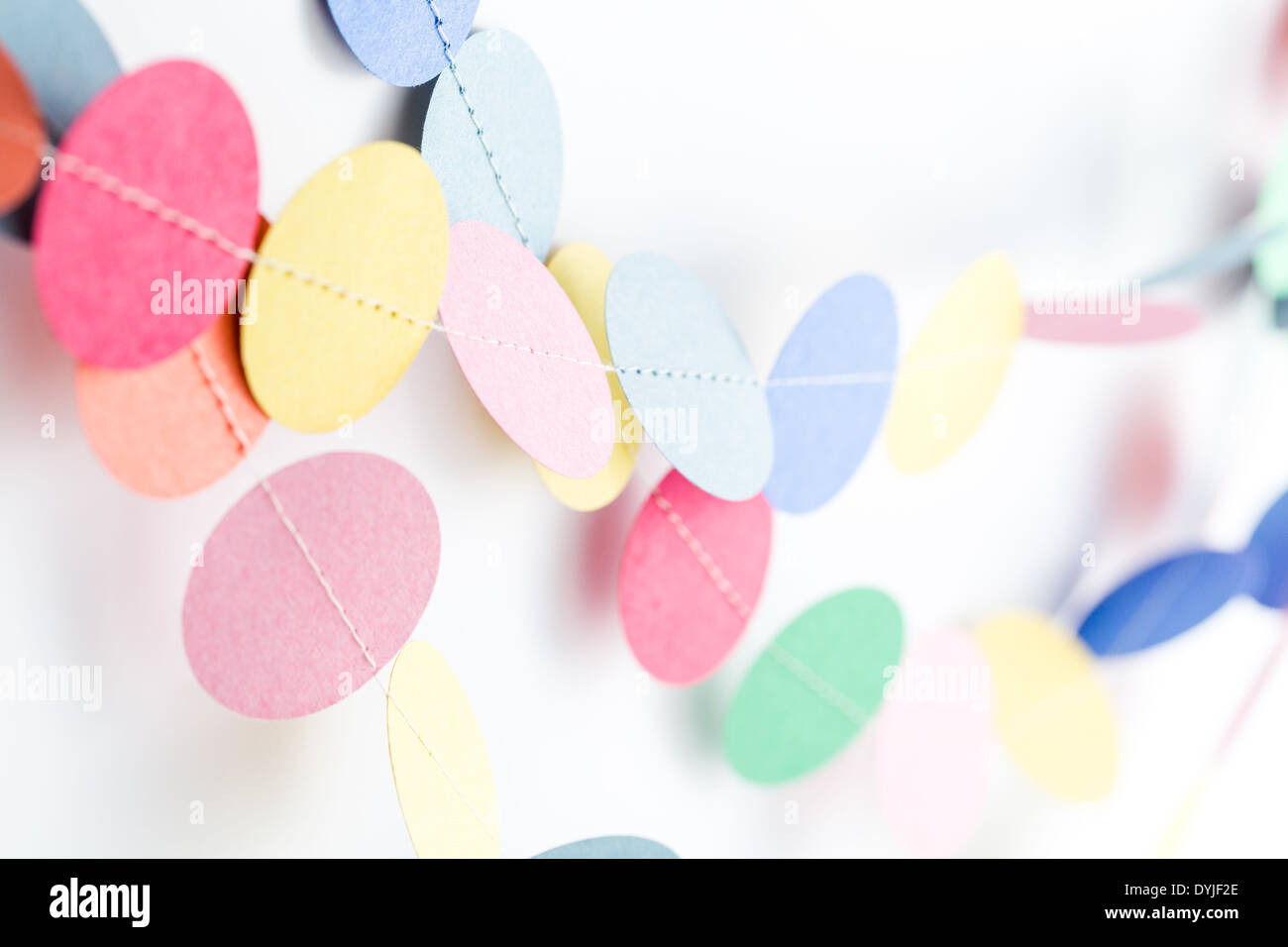 Making a colorful paper garland with reound puncher Stock Photo - Alamy