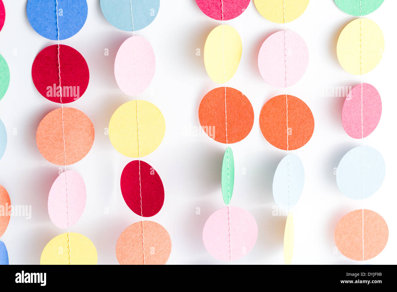 Making a colorful paper garland with reound puncher Stock Photo - Alamy