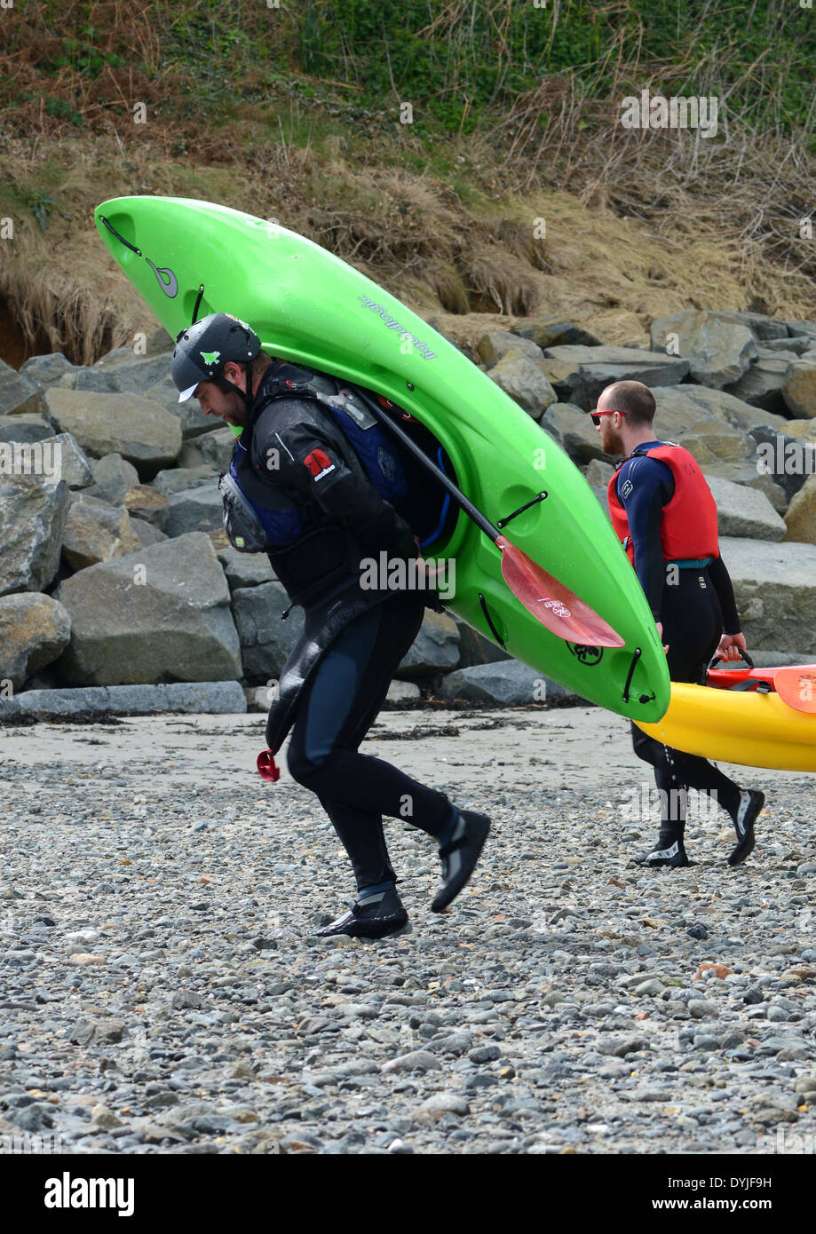 A man carrying a sea kayak Stock Photo - Alamy