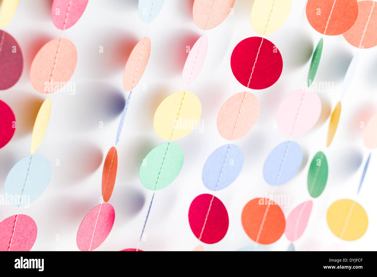 Making a colorful paper garland with reound puncher Stock Photo - Alamy
