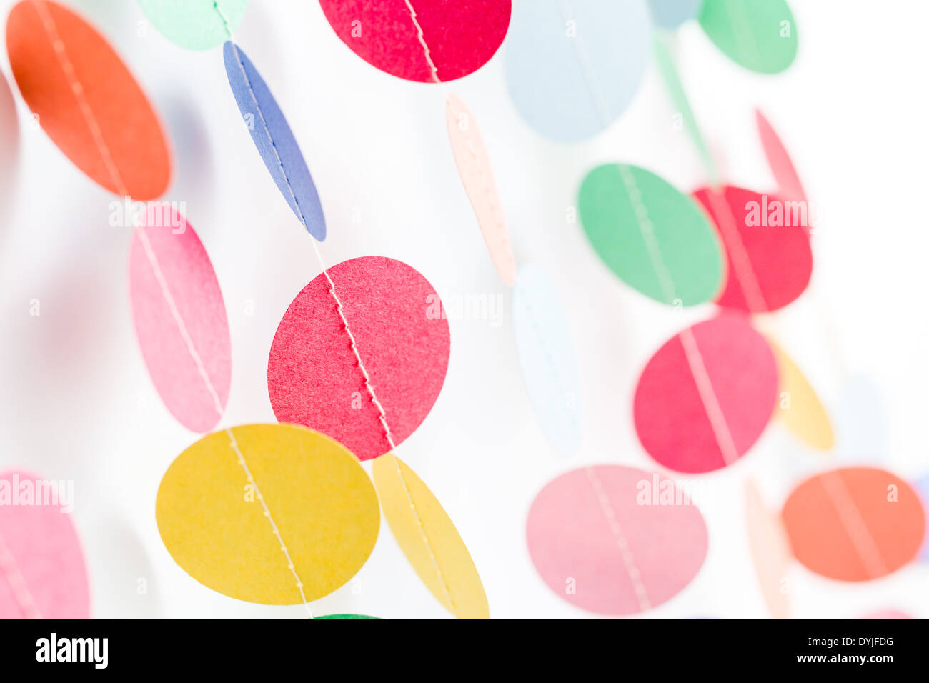 Making a colorful paper garland with reound puncher Stock Photo - Alamy