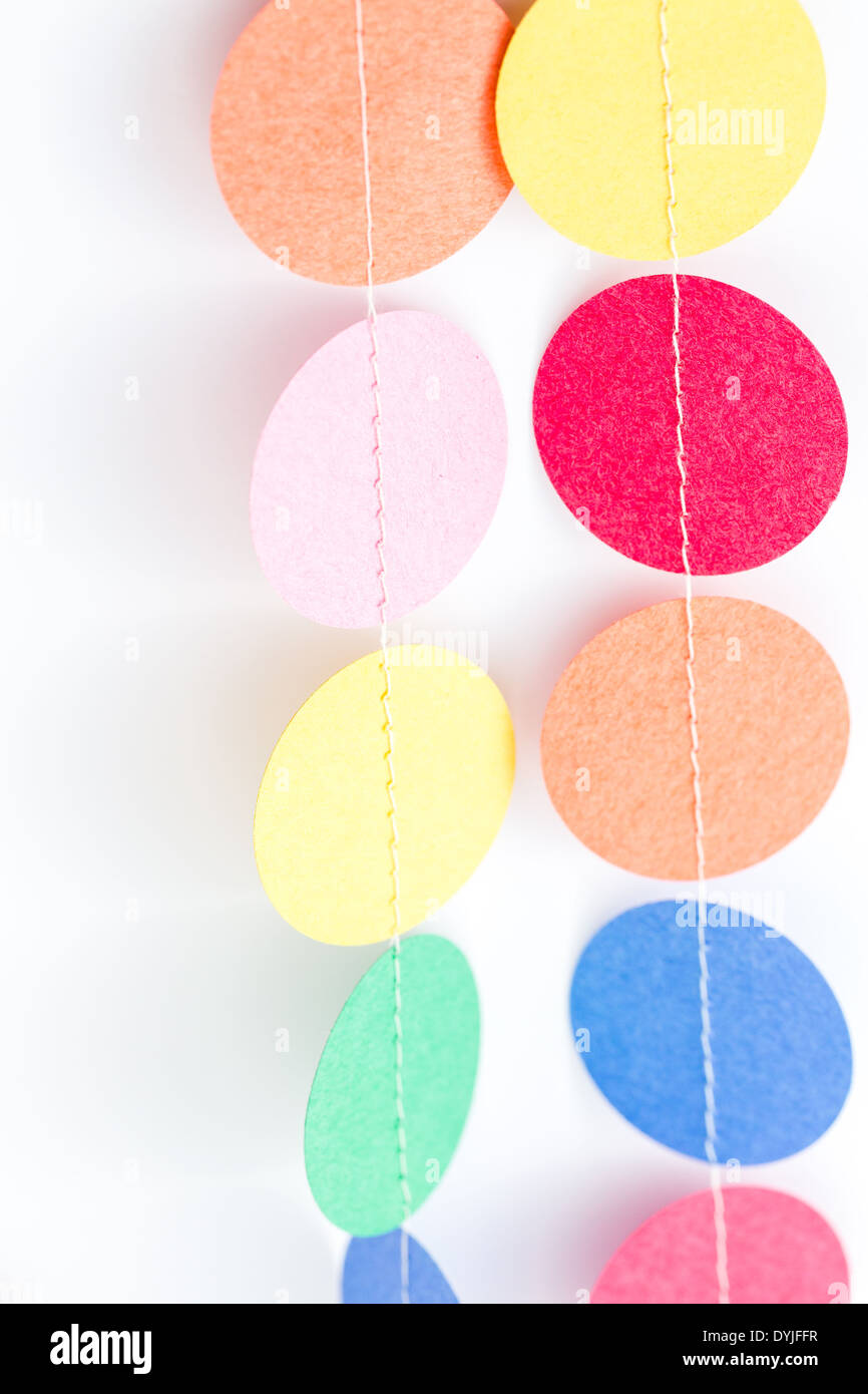 Making a colorful paper garland with reound puncher Stock Photo - Alamy