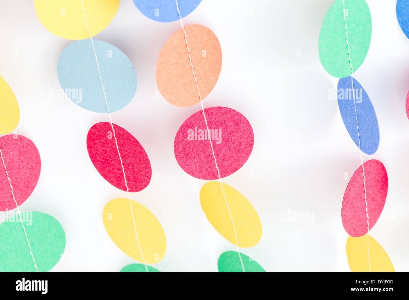 Making a colorful paper garland with reound puncher Stock Photo - Alamy