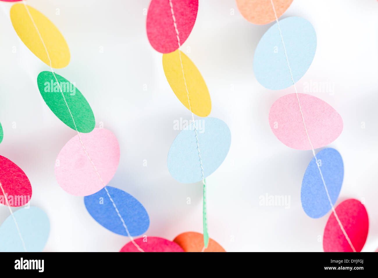Making a colorful paper garland with reound puncher Stock Photo - Alamy