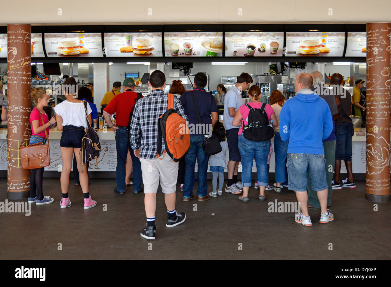 Interior back view of McDonalds fast food restaurant people wait at ...