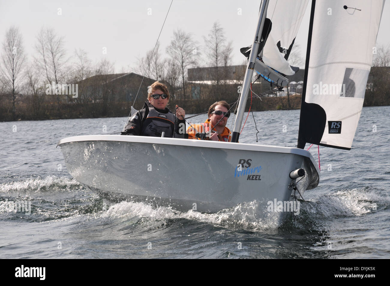 A disabled sailor receives instruction in a dual purpose sailing dinghy ...