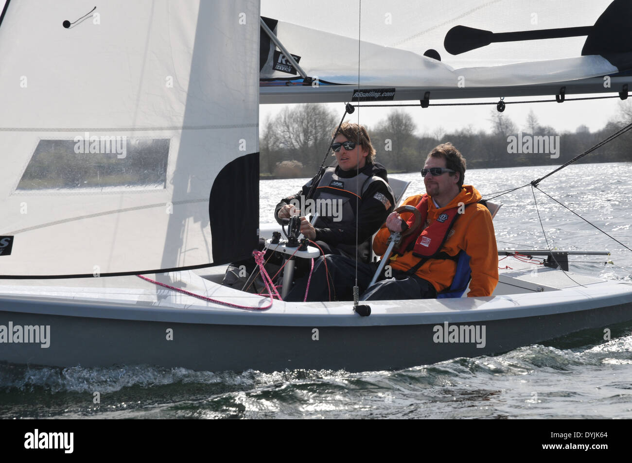 A disabled sailor receives instruction in a dual purpose sailing dinghy ...