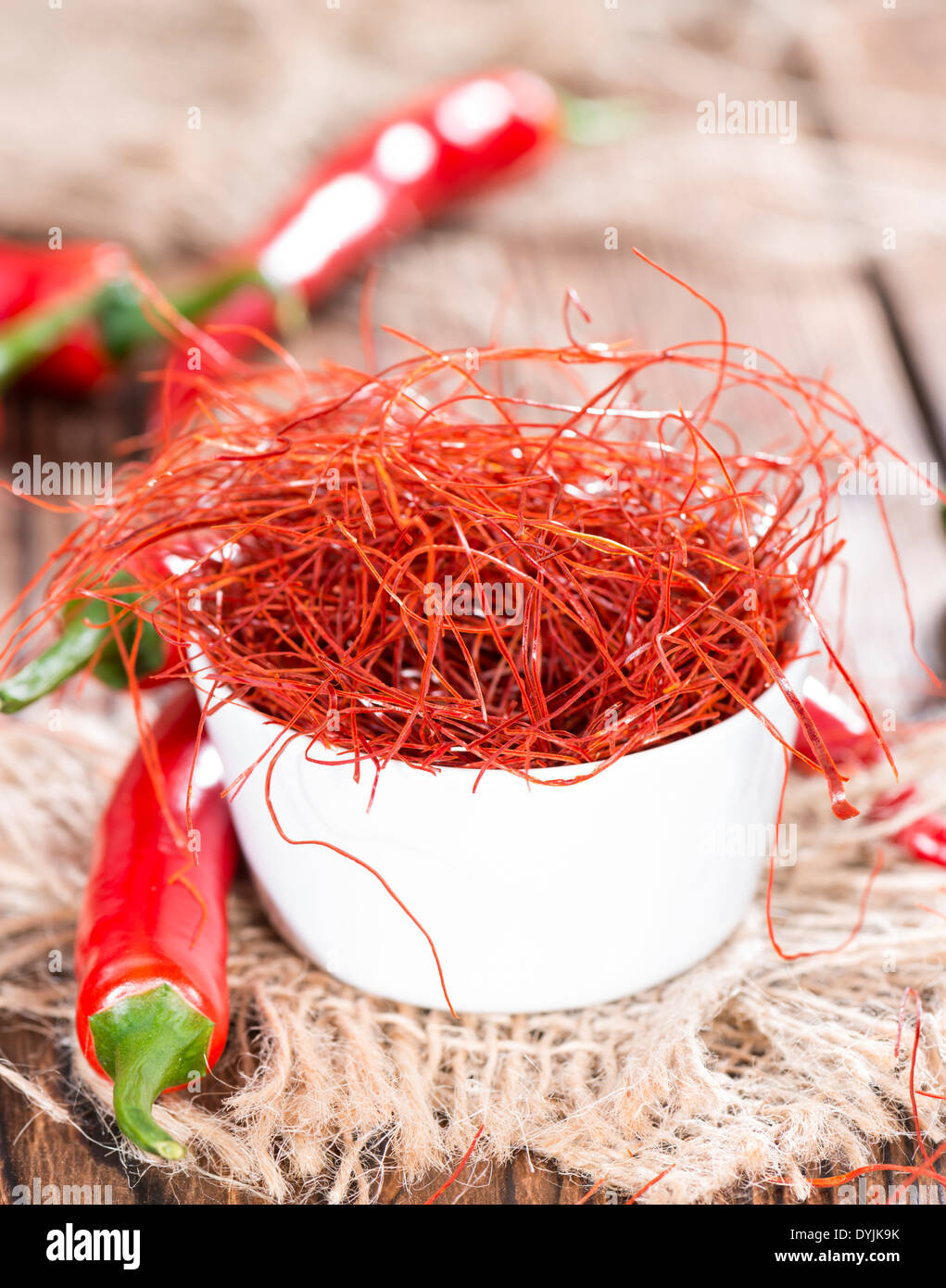Hot red Chilli Strings on vintage wooden background Stock Photo - Alamy