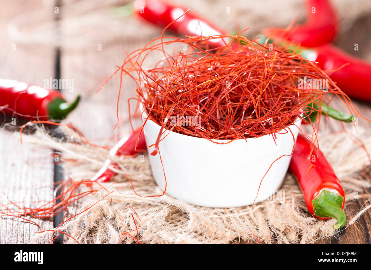 Small portion of dried Chilli Strings on wooden background Stock Photo ...
