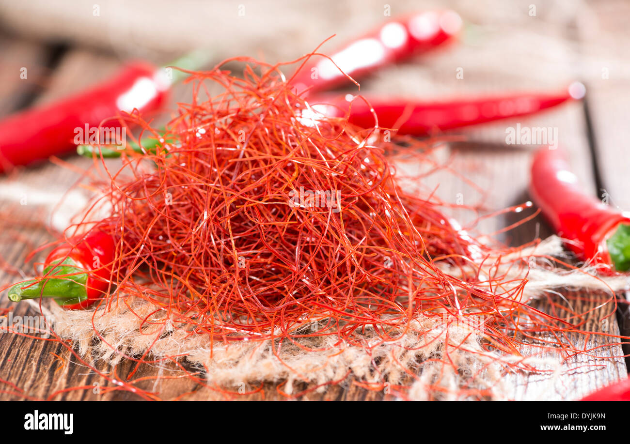 Small portion of dried Chilli Strings on wooden background Stock Photo ...