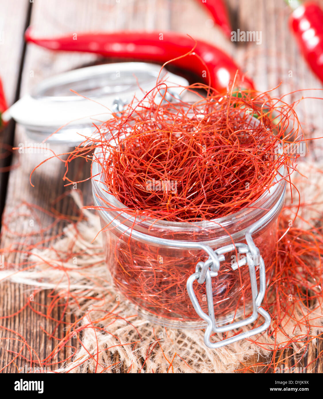 Small portion of dried Chilli Strings on wooden background Stock Photo ...